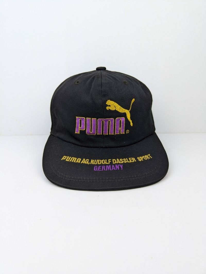Topi Puma Rudolf Dassler Black Purple Gold - Preloved